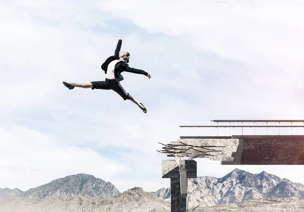 Woman jumping over huge gap — Stock Photo © Khakimullin #179905218