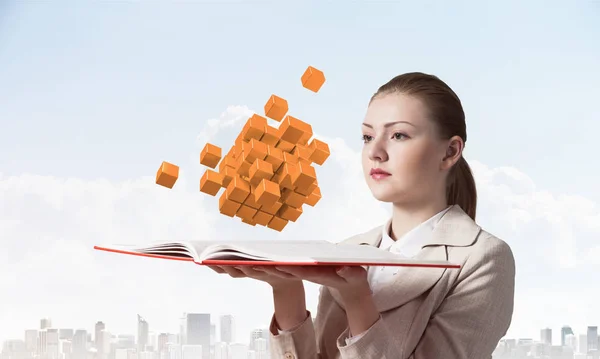 Young woman holding open notebook with flying abstract 3d cubes. Hi ...