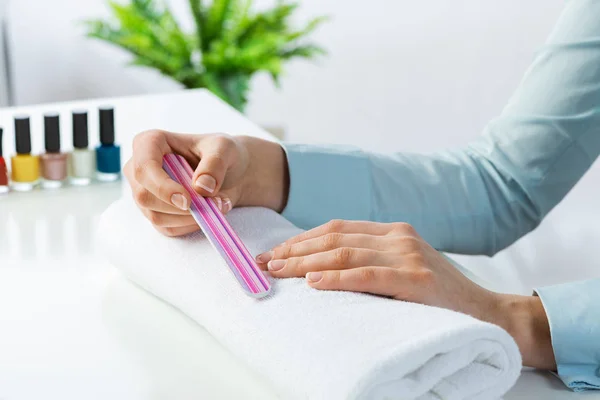 Woman hand using nail file and create perfect nails shape. Closeup ...