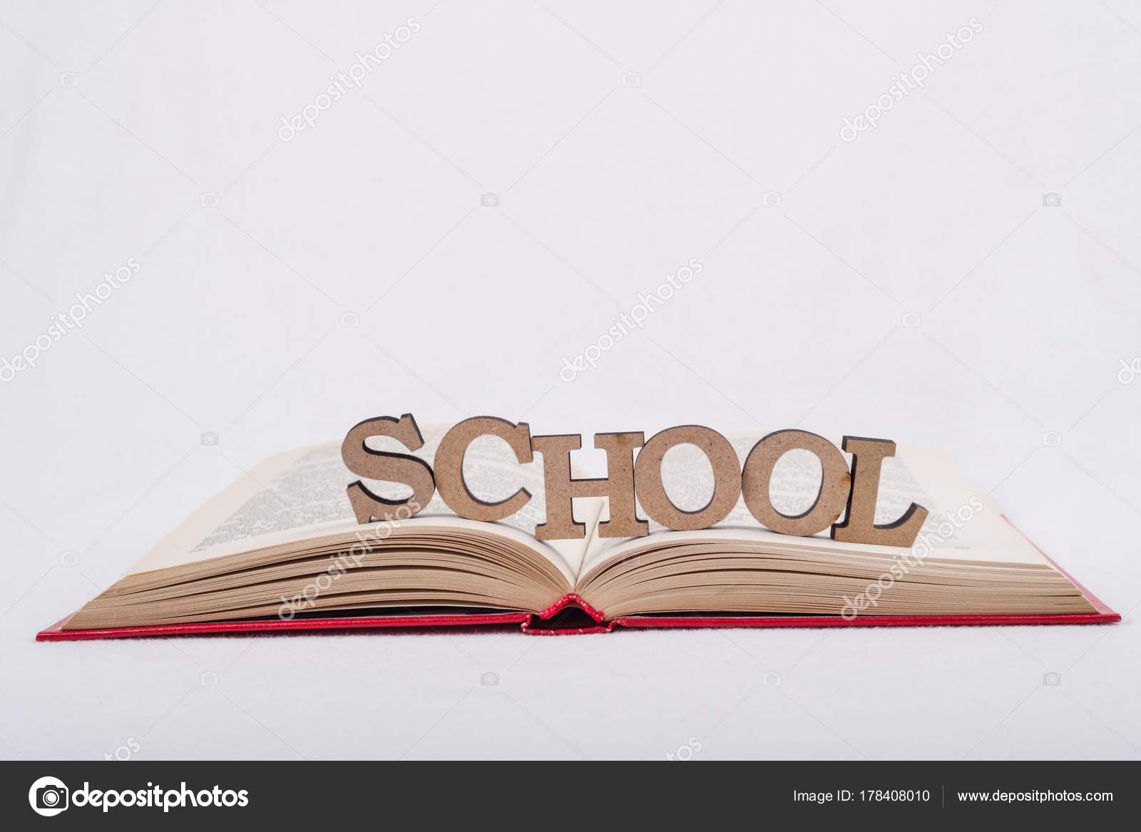 Open book on white background. Word school wooden abstract letters ...