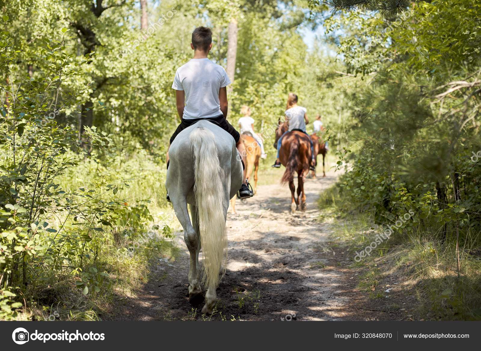 Group of teenagers on horseback riding in summer park — Stock Photo ...