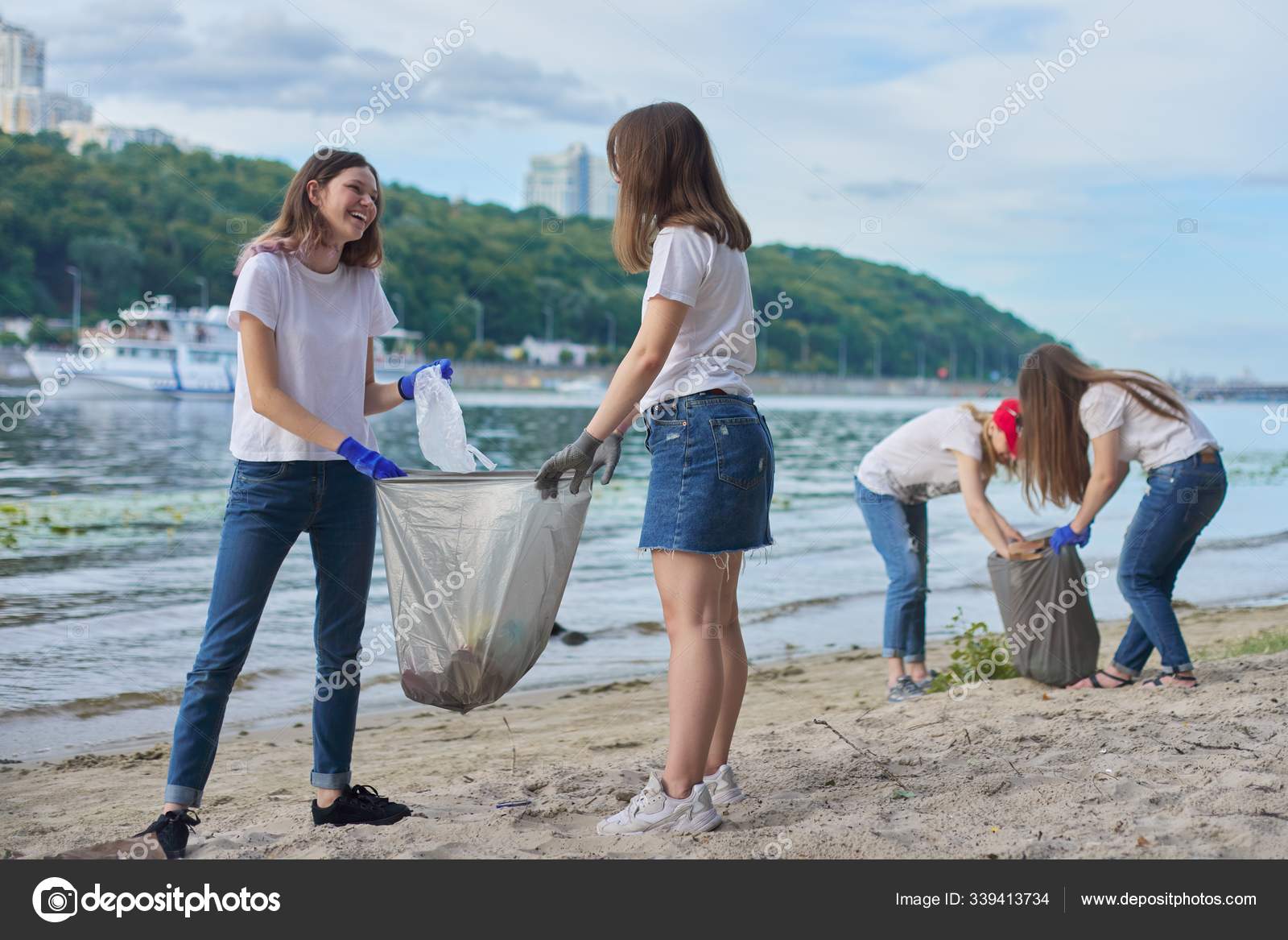 Group of students with teacher in nature doing cleaning of plastic ...