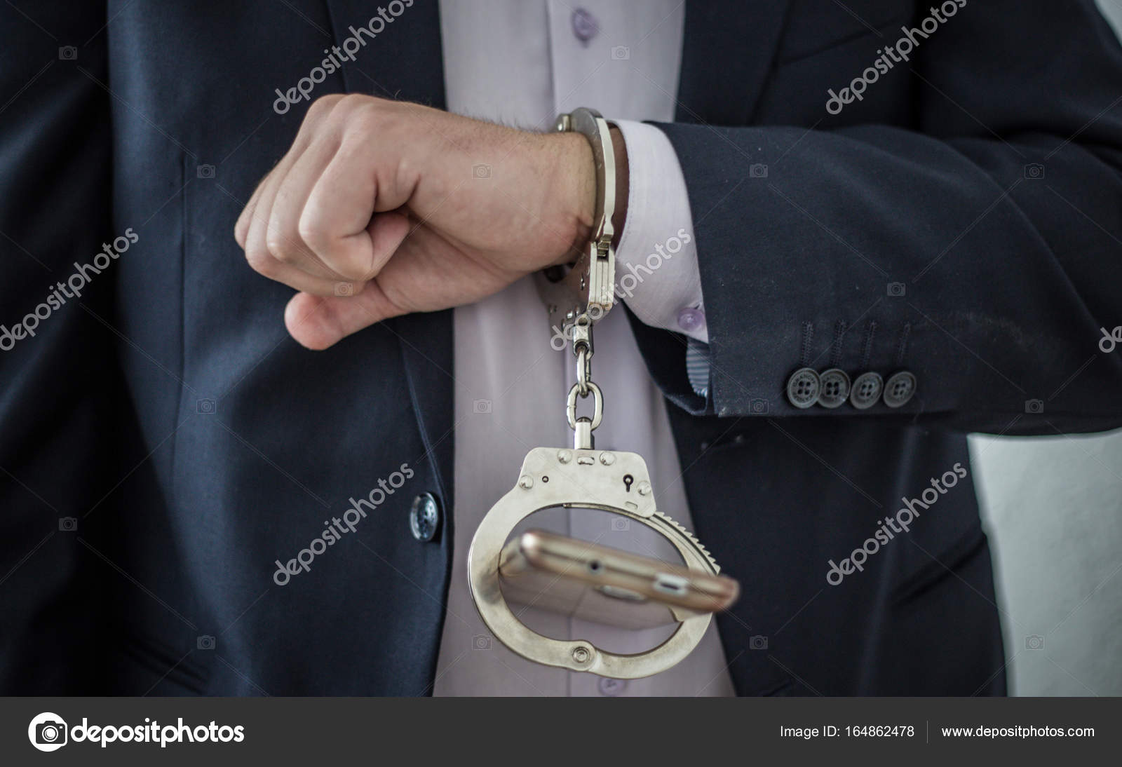 A businessman caught with handcuffs on his stomach for corruptio Stock ...