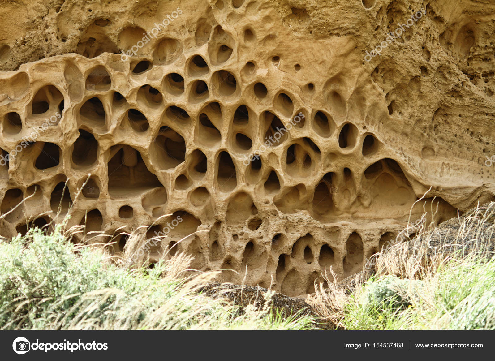 Wind eroded yellow limestone mountain with a lot of small holes ⬇ Stock ...
