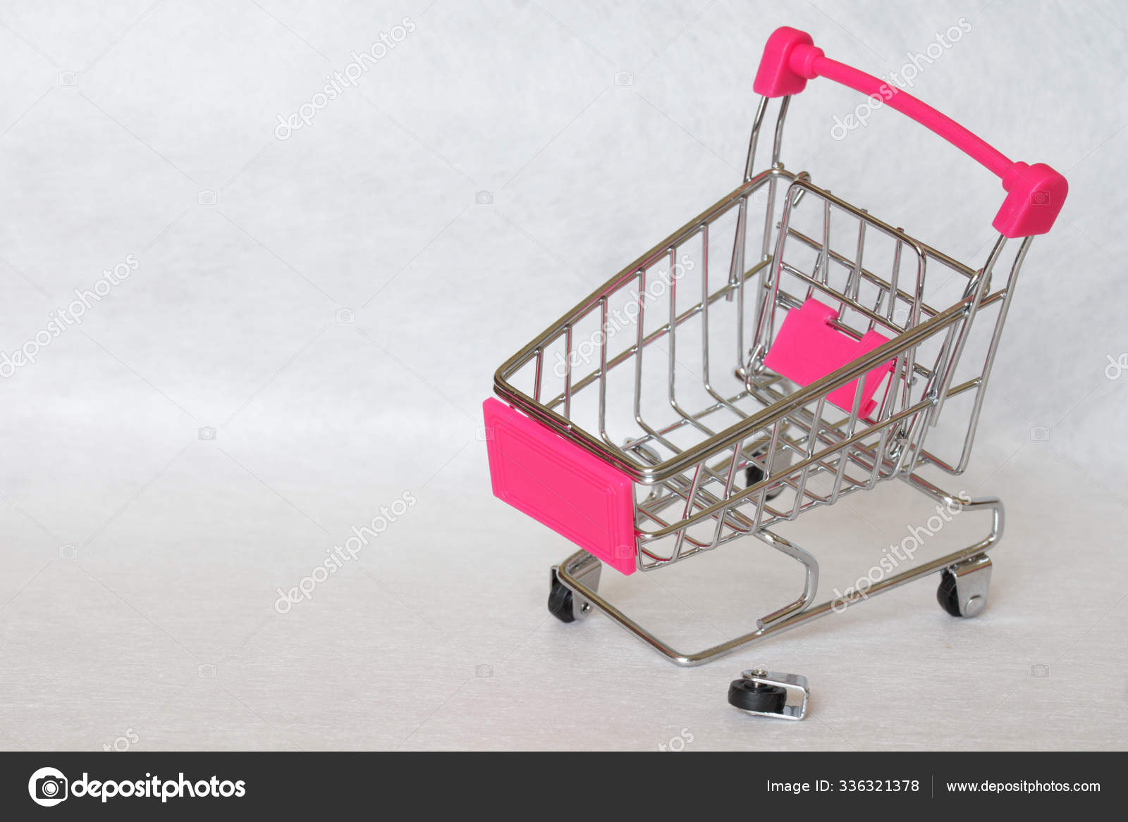 Empty and broken supermarket cart with a falling wheel on a whit Stock ...
