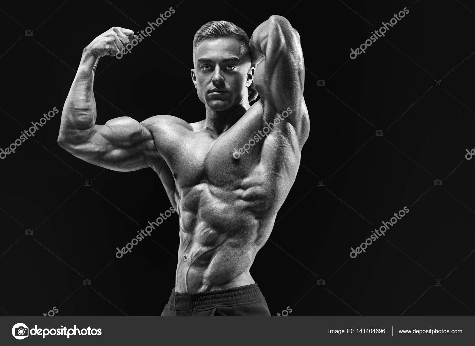 Bodybuilder with muscular physique looking at camera showing bic Stock ...