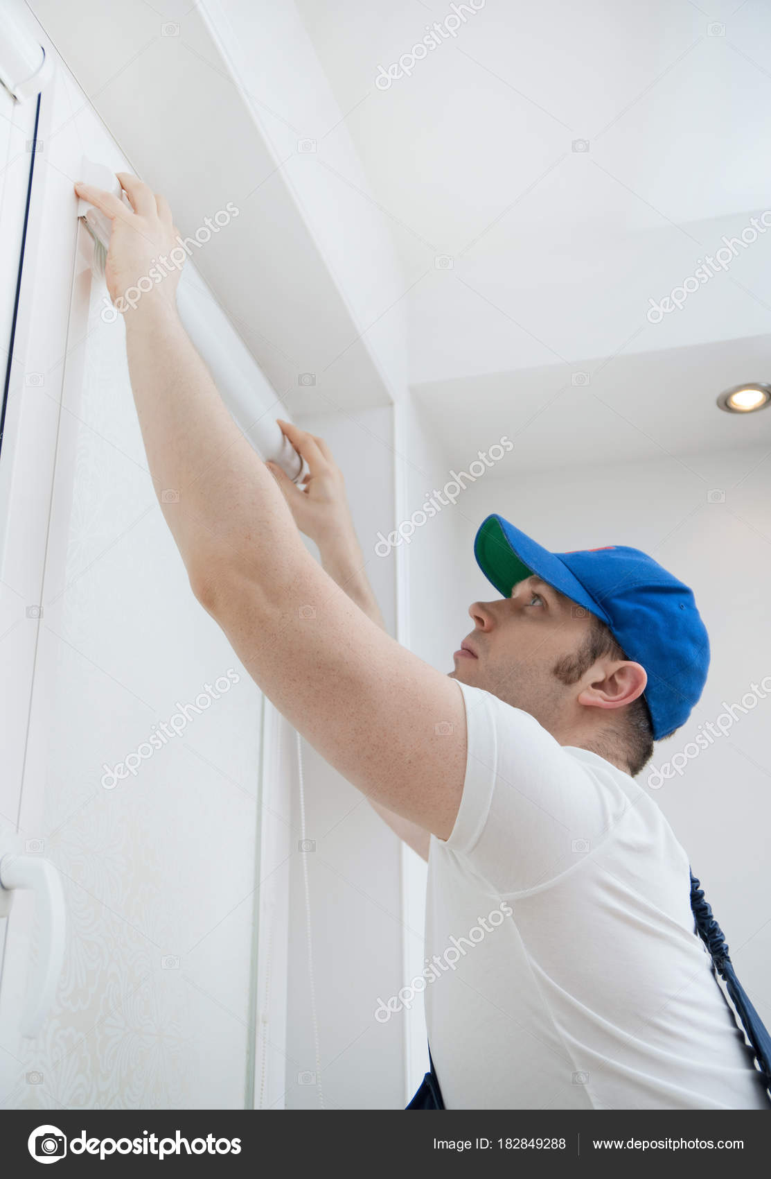 Handsome handyman installing cassette roller blinds. Stock Photo by ... Handsome handyman installing cassette roller blinds. Stock Photo by ...