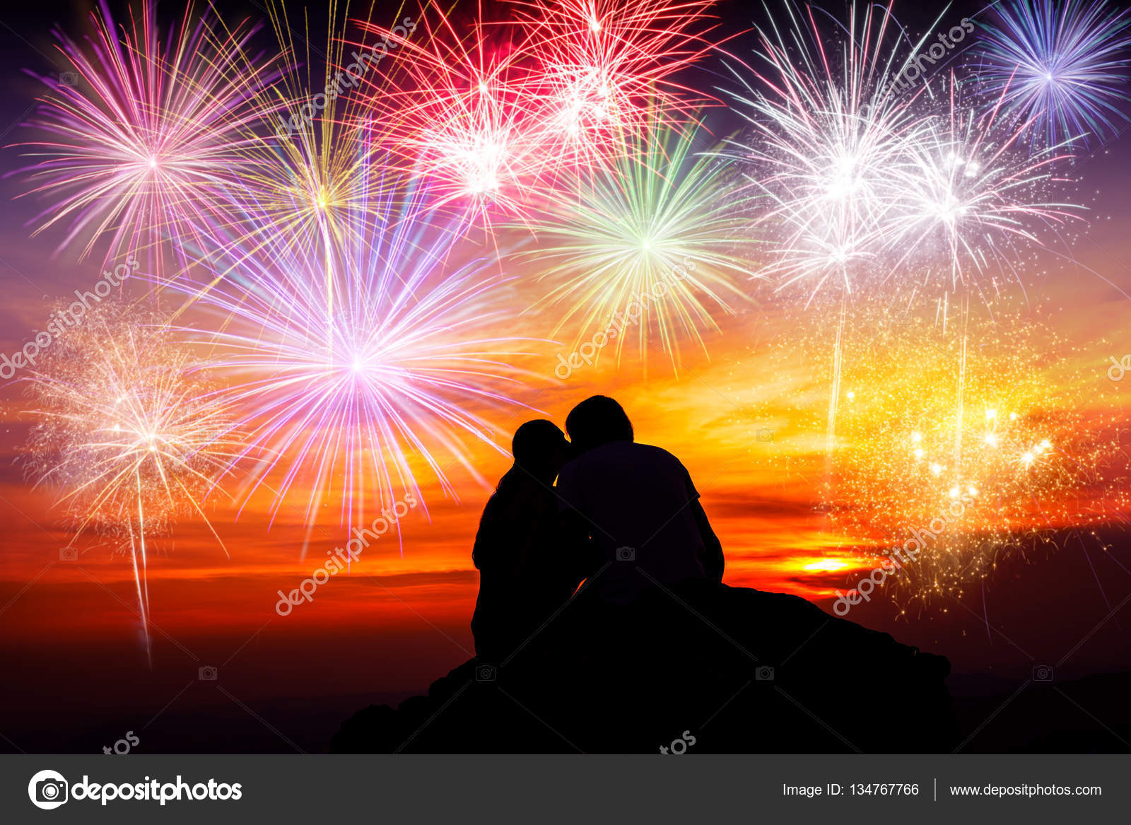 Happy couple sitting on floor and watching the fireworks Stock Photo by ...
