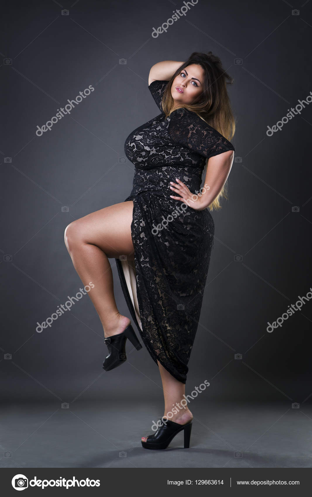 Young beautiful plus size model in black dres, xxl woman on gray studio ...