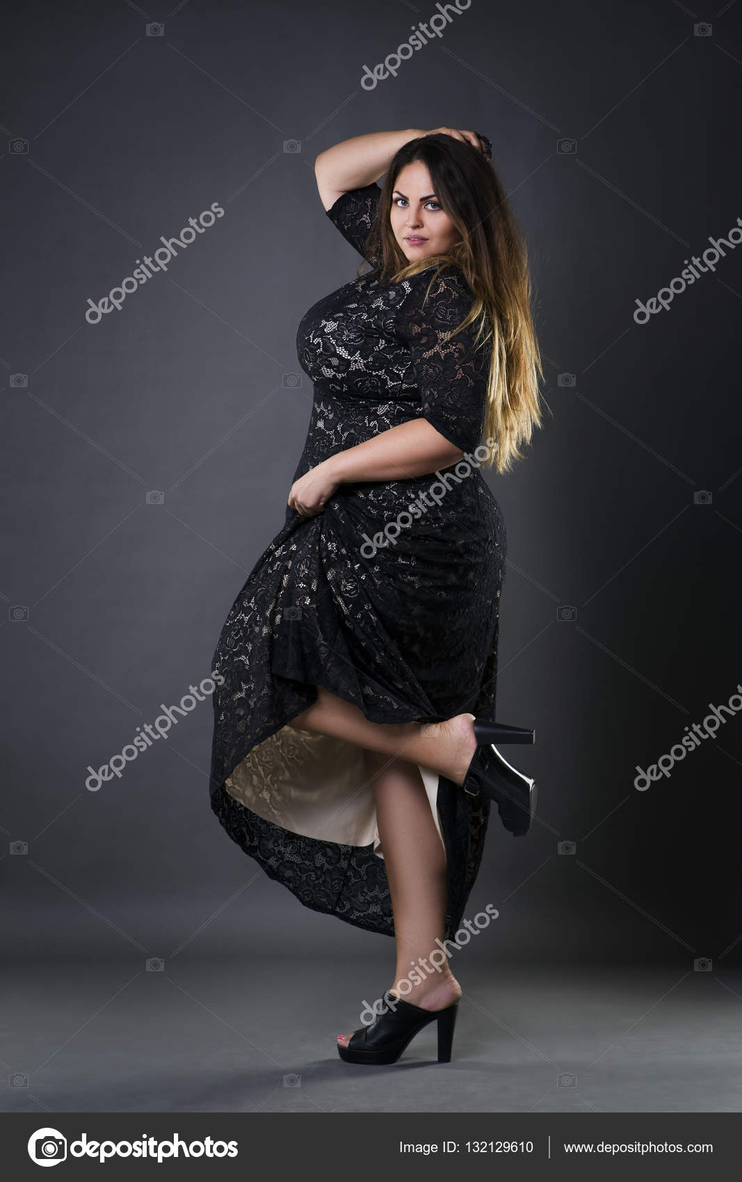 Young beautiful plus size model in black dres, xxl woman on gray studio ...