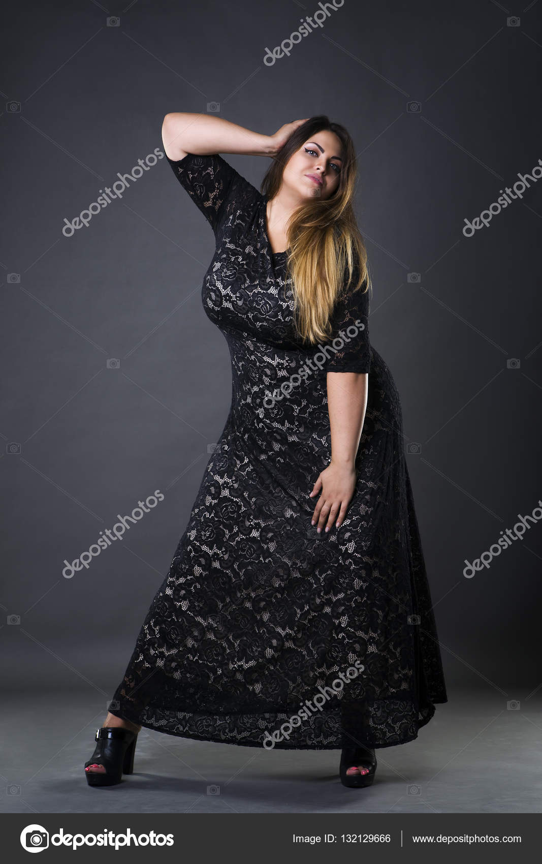 Young beautiful plus size model in black dres, xxl woman on gray studio ...