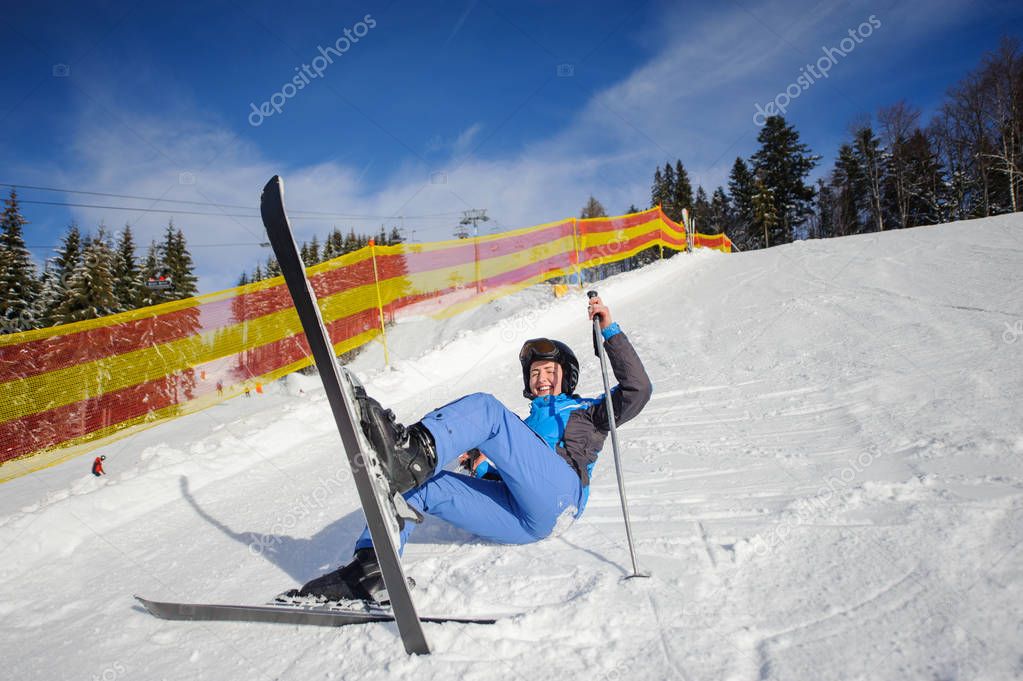 Young female skier after the fall on mountain slope — Stock Photo ...