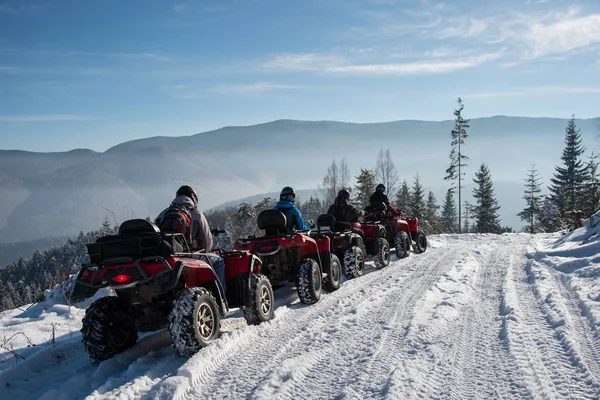 Group of people sitting on off-road four-wheelers ATV bikes in the the ...