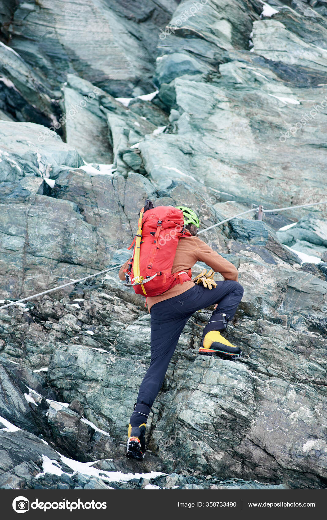 Back View Male Alpinist Backpack Using Rope While Climbing Alpine ...