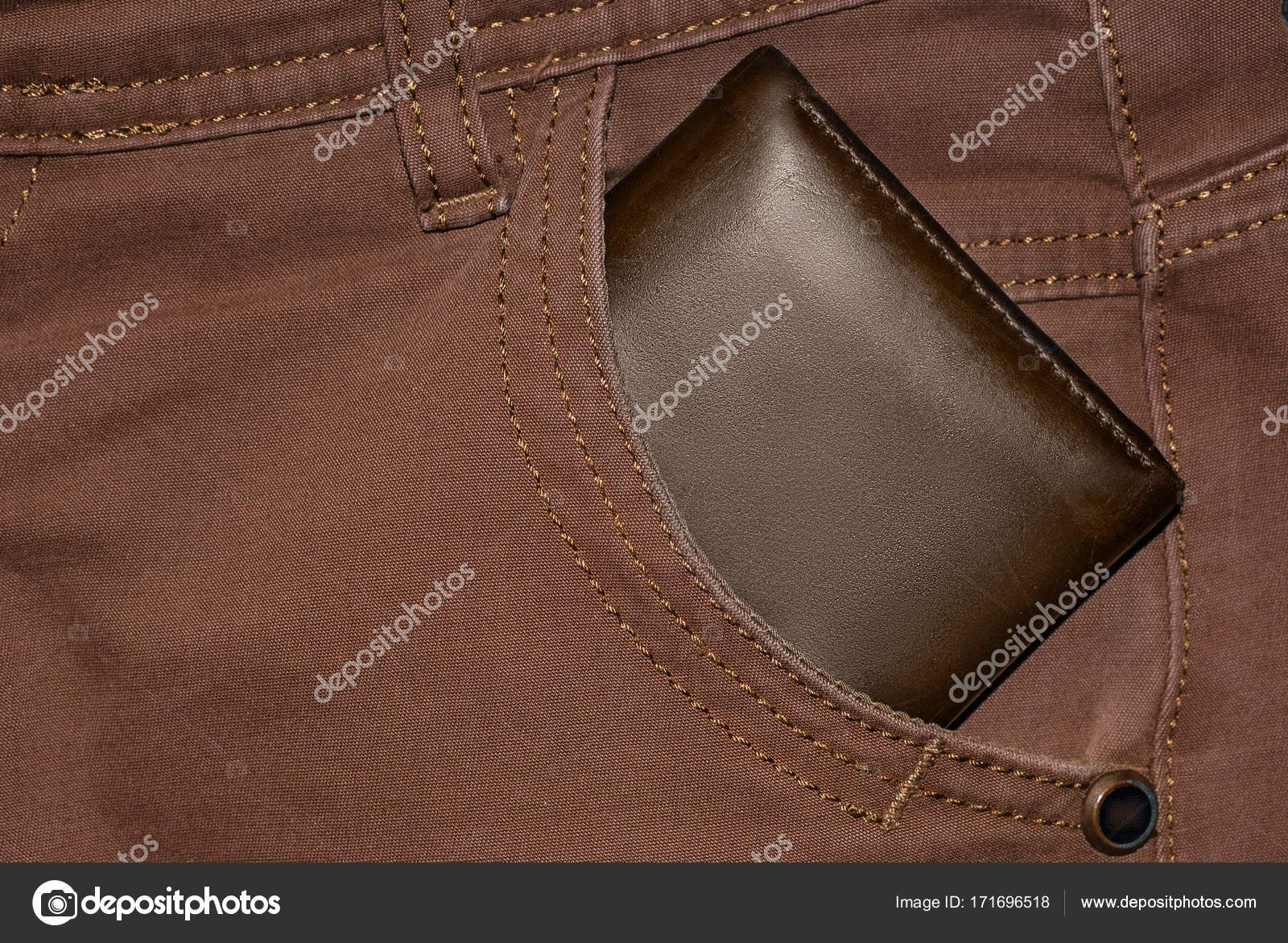 Brown leather purse in the pocket. Wallet halfway out from a jeans back ...