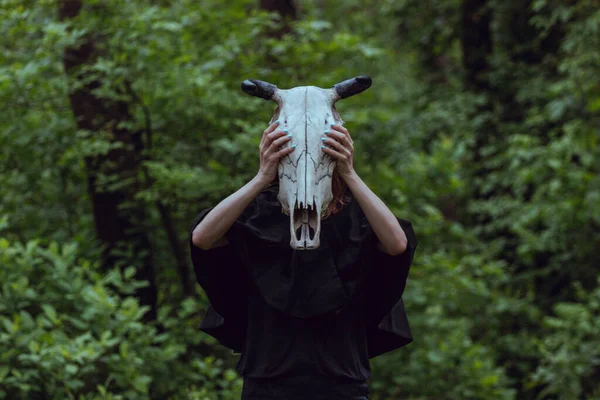 Victim with skull of the animal instead of head. Photo stylized as ...