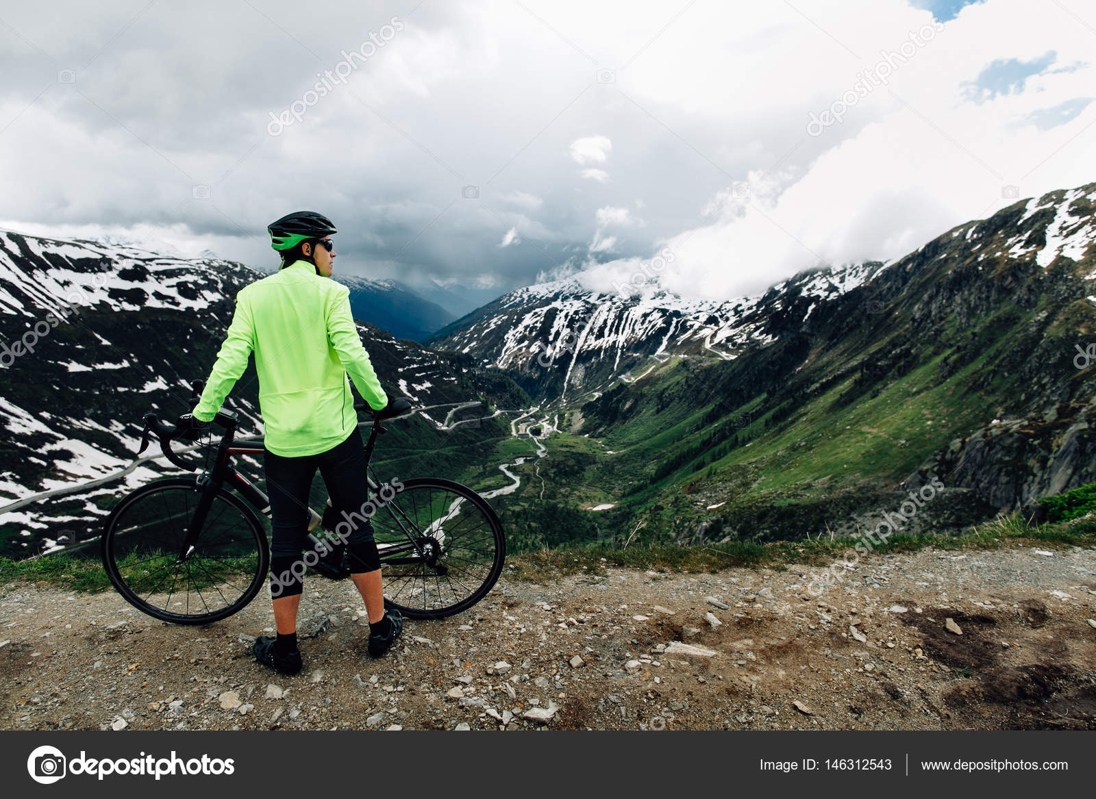 Cyclist standing with road bikes on background of beautiful Alpine ...