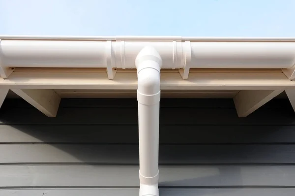 New rain gutter on a home against blue sky. New roof. Stock Photo by ...