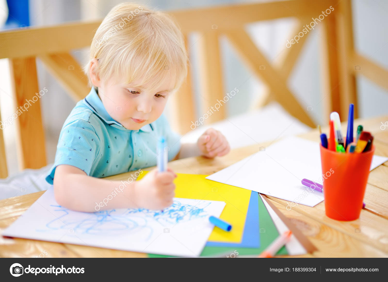 Cute little boy drawing and painting with colorful markers at ...