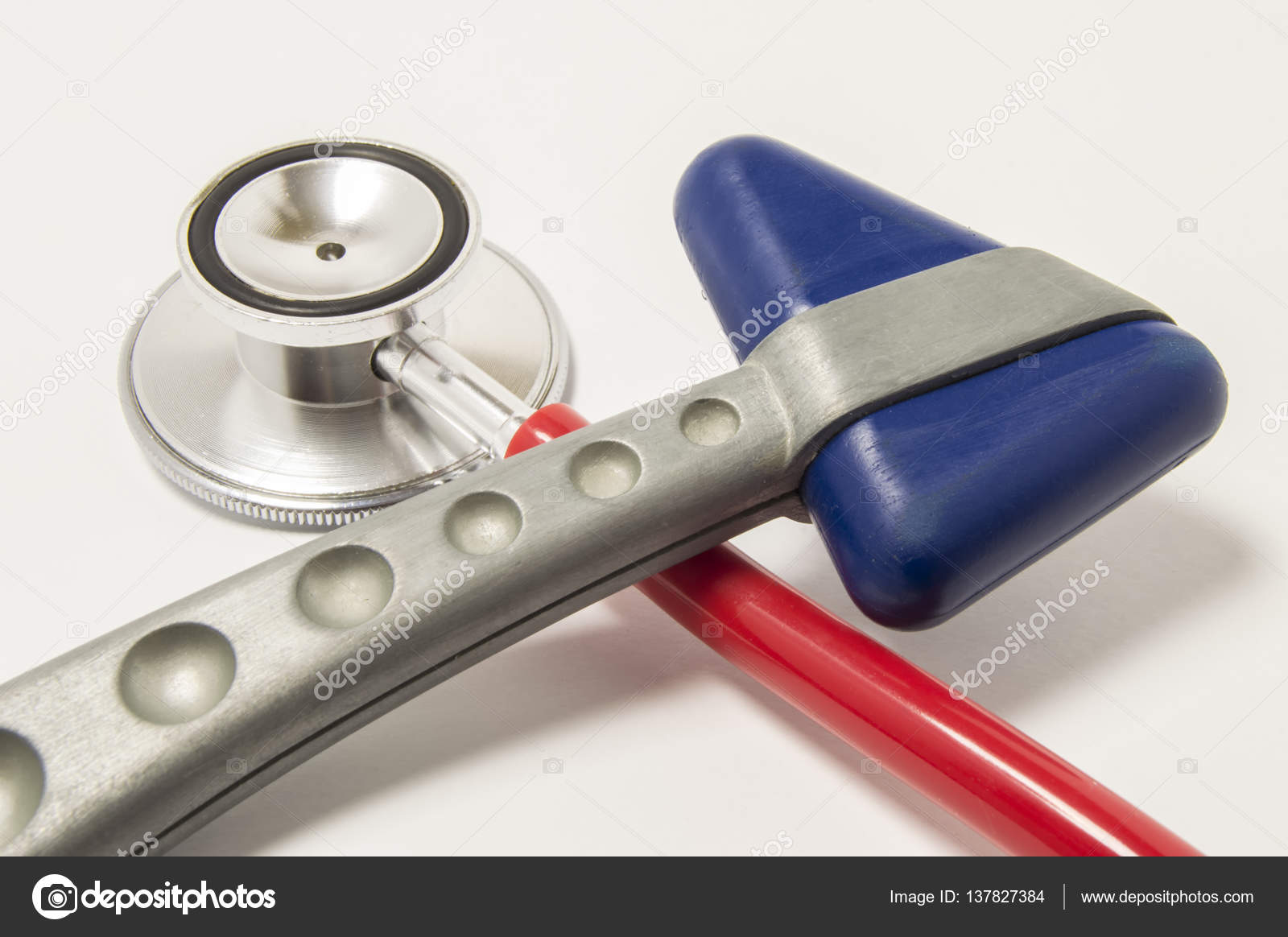 Red stethoscope and neurological reflex hammer with blue triangular ...