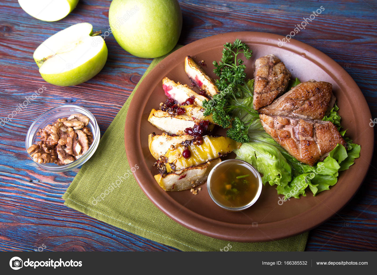 Roasted duck chops with apples walnuts and cranberry, top view Stock ...