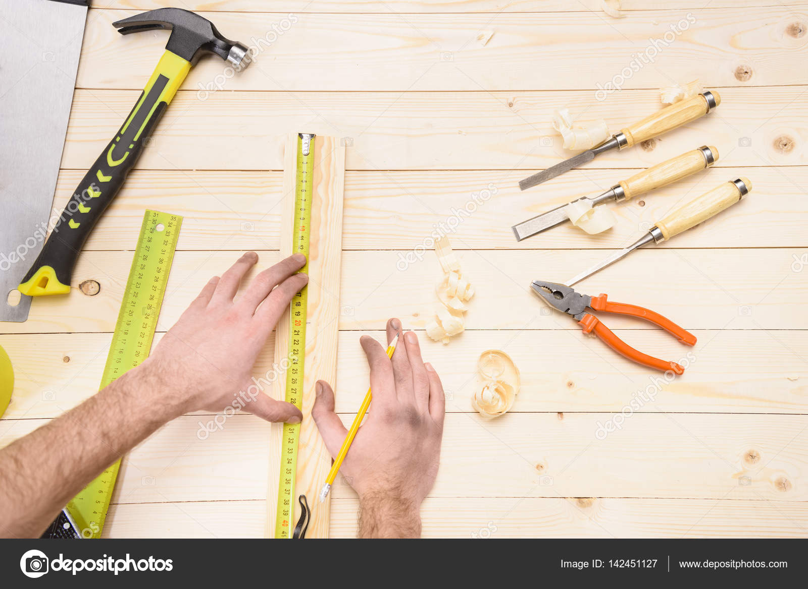 Carpenter measuring plank Stock Photo by ©NatashaFedorova 142451127