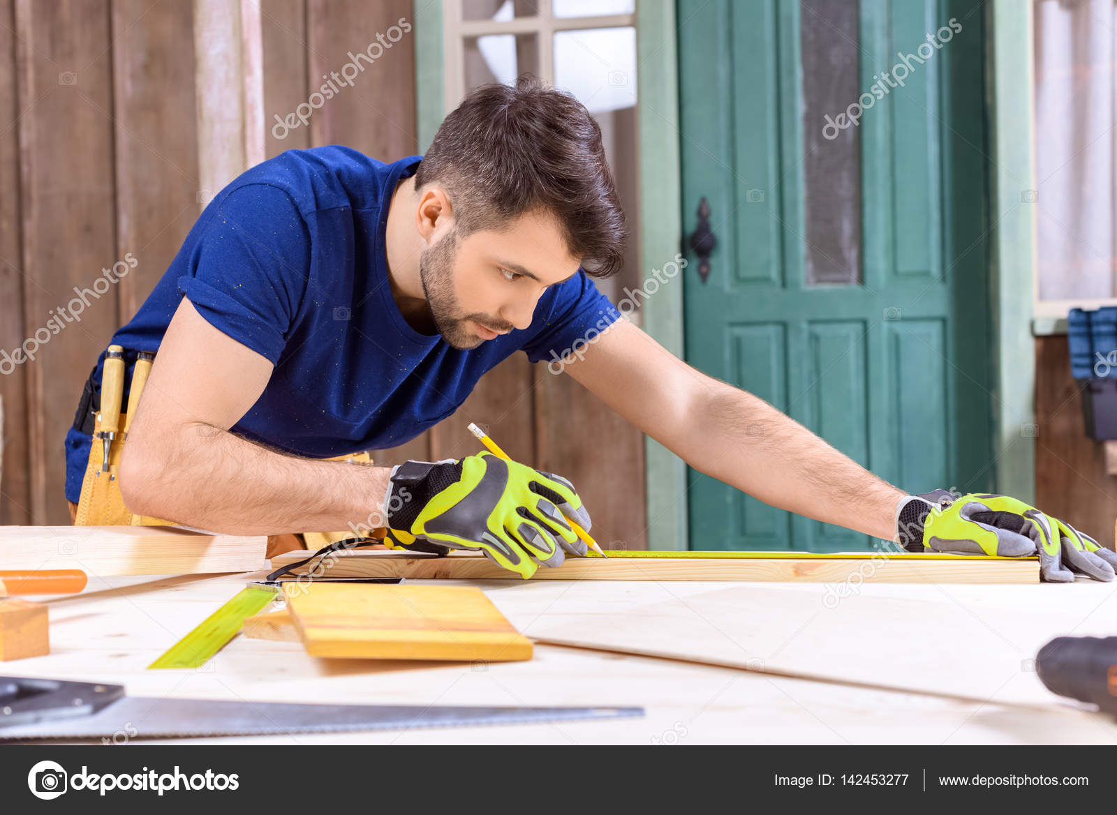Carpenter working with wooden plank — Stock Photo © NatashaFedorova ...