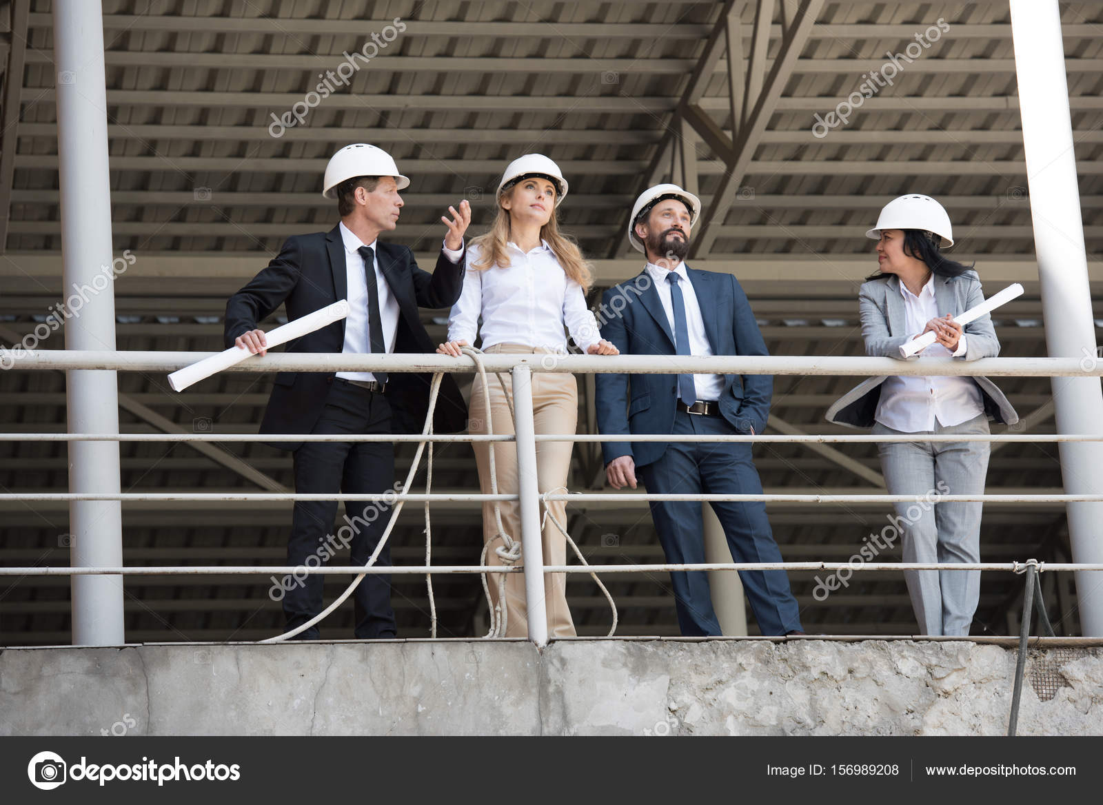 Group of architects talking at construction site — Stock Photo ...