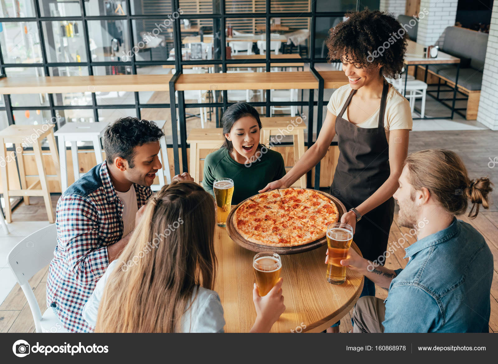 Waitress bringing pizza for clients Stock Photo by ©NatashaFedorova ...