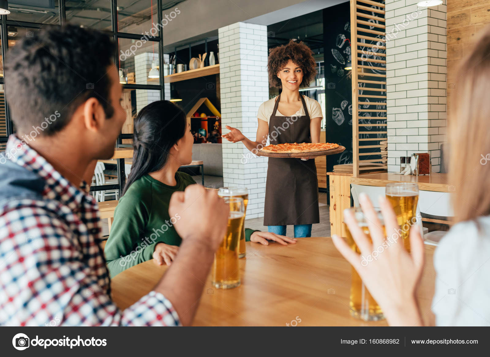 Waitress bringing pizza for clients — Stock Photo © NatashaFedorova ...