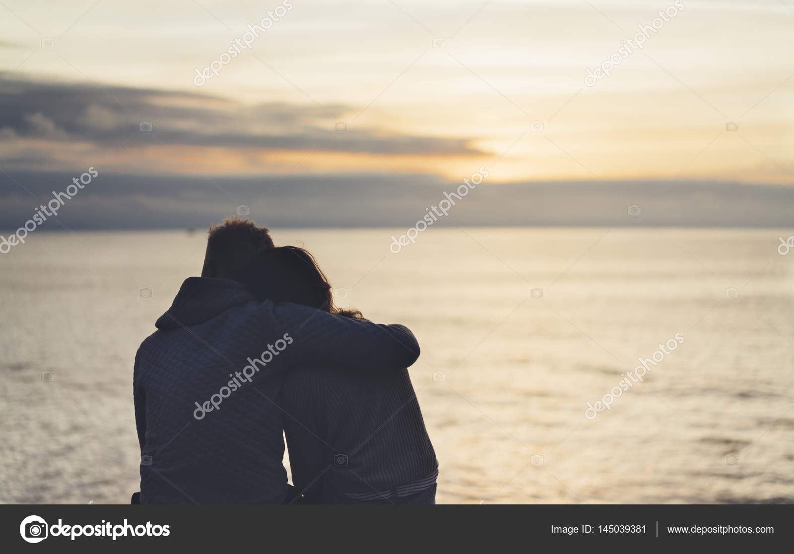 Couple hugging on the beach on background ocean sunrise, silhouette two ...