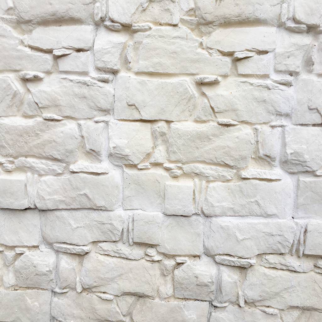 White painted stone wall texture as background. Cracked concrete ...
