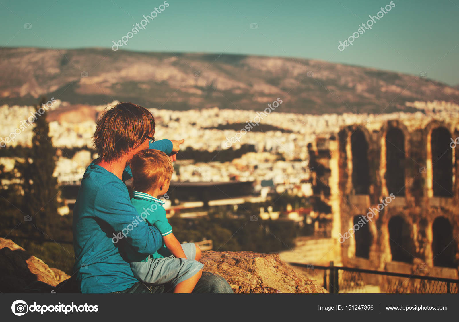 Father and son looking at the city of Athens, Greece from Acropolis ...