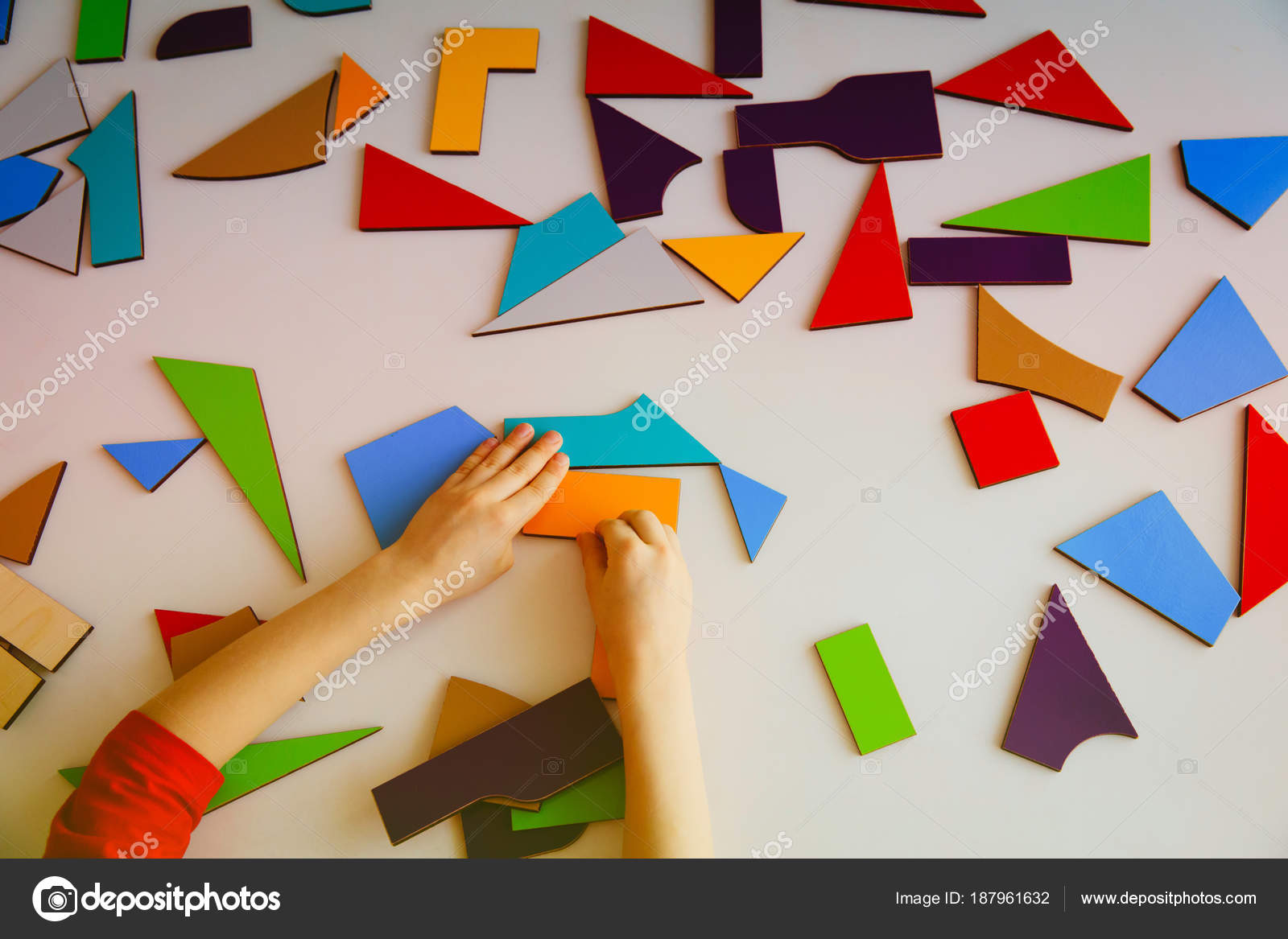 Child playing with puzzle or tangram, education Stock Photo by ...