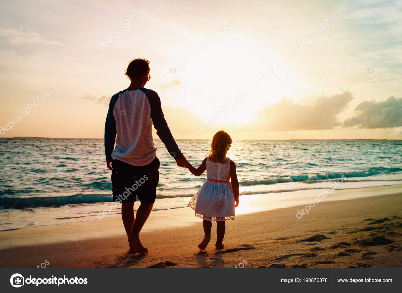 Father and daughter walking on beach at sunset Stock Photo by ...