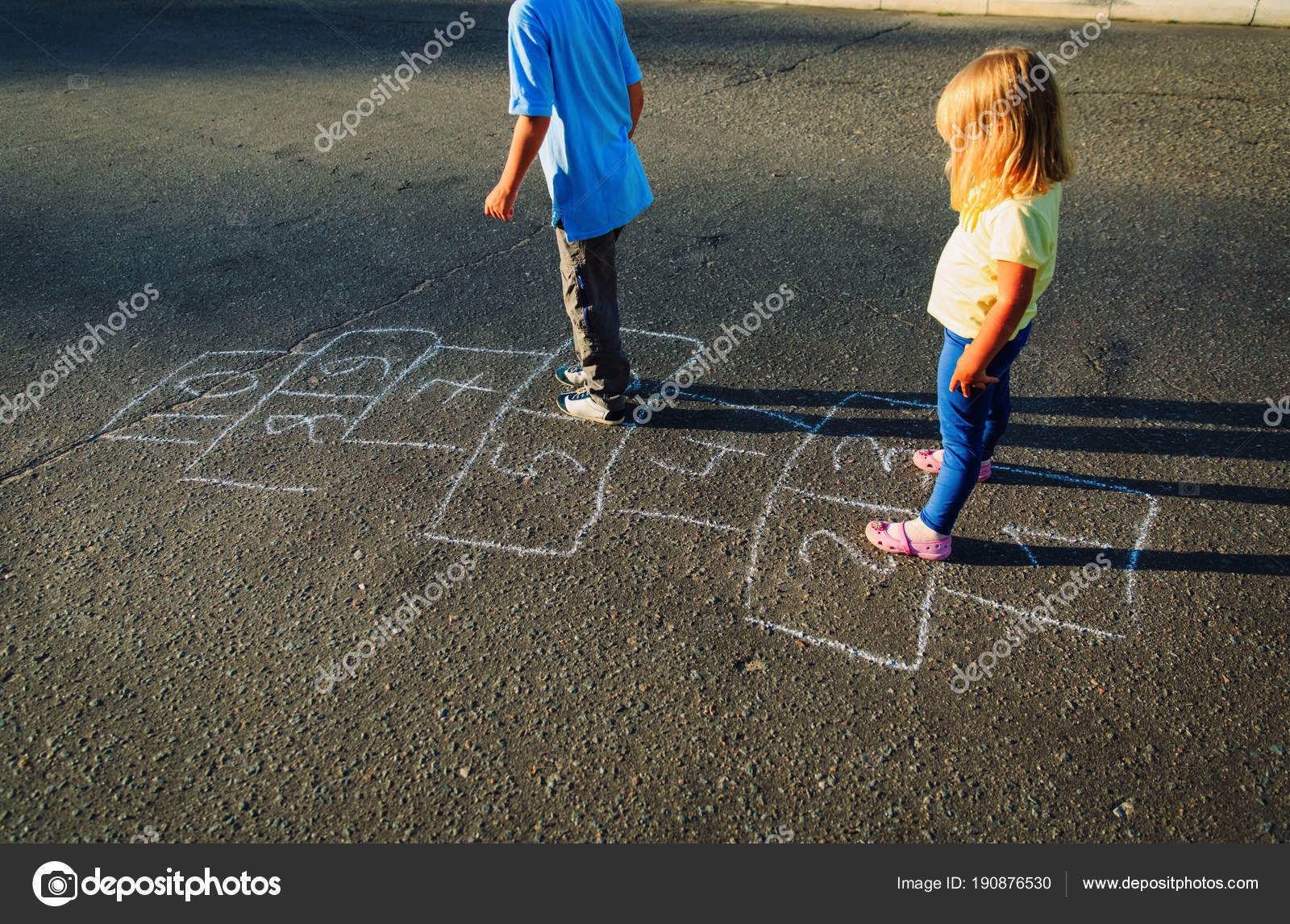 Kids playing hopscotch on playground Stock Photo by ©Nadezhda1906 190876530