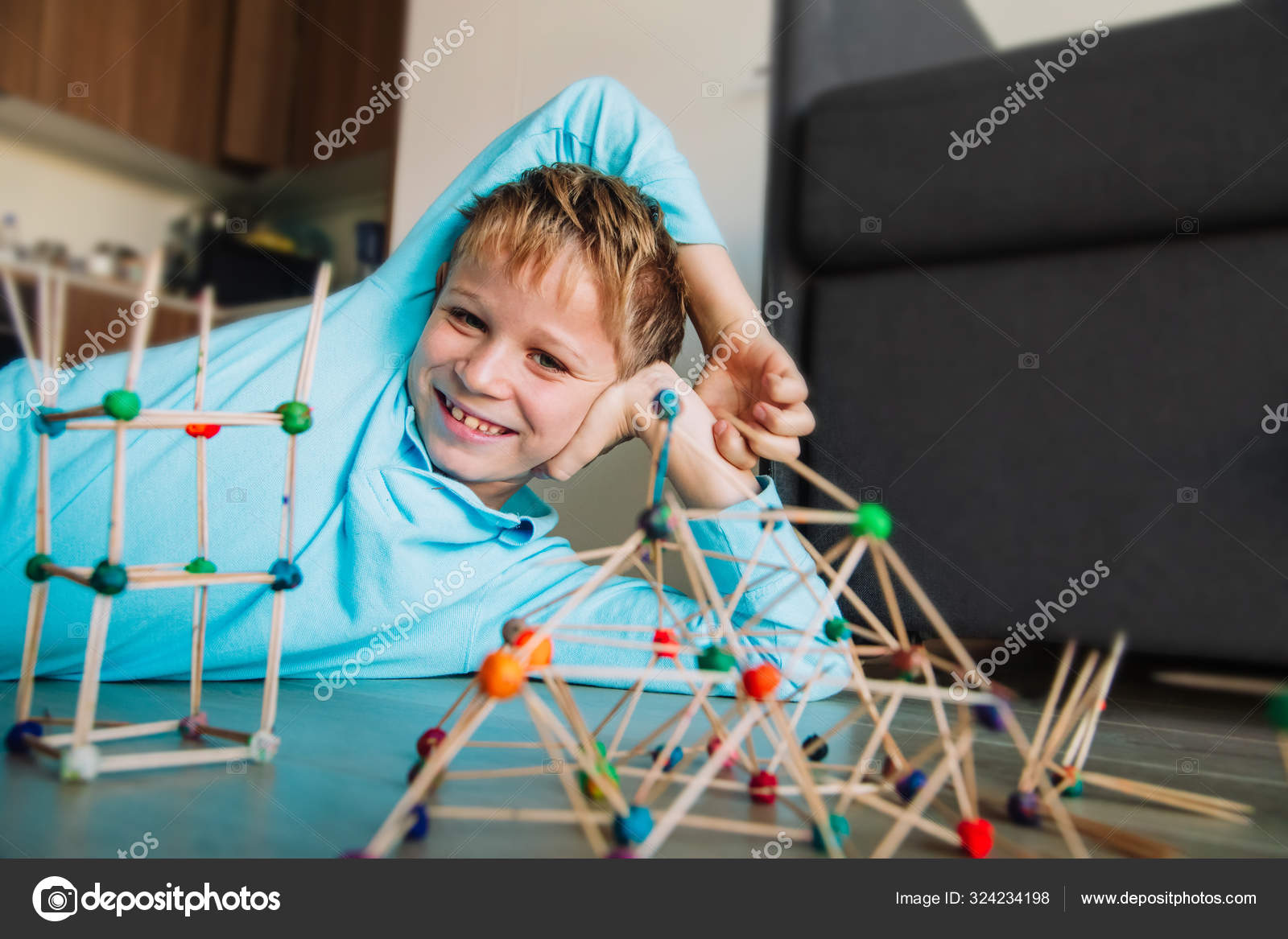 Happy boy making geometric shapes from sticks and clay, engineering and ...