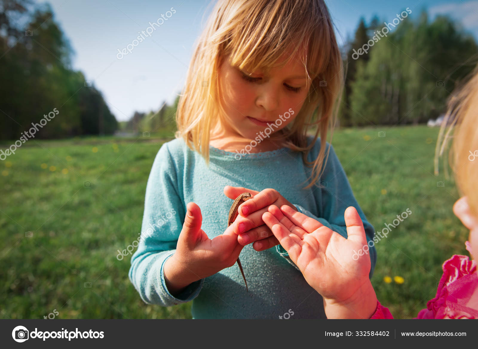 Kids learning - kids holding and exploring lizard Stock Photo by ...