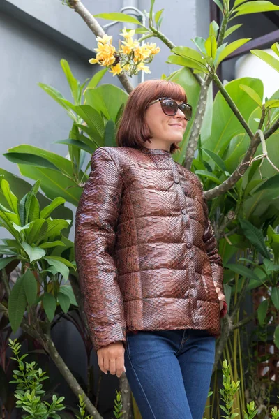 Beautiful lady dressed a luxury snaskin python coat and sunglasses ...