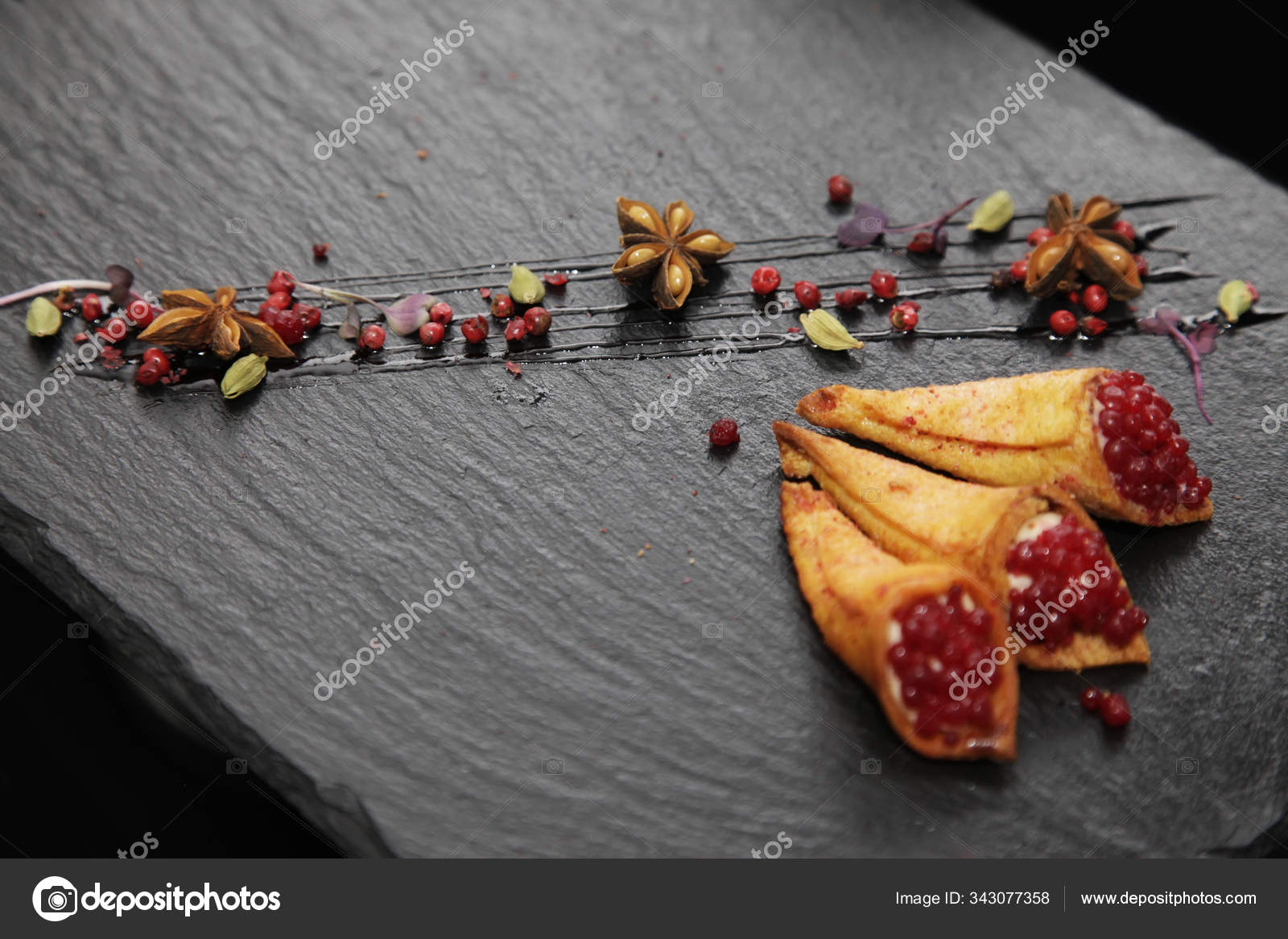 Rabbit pate in crispy horns decorated with spices on a black sto Stock ...