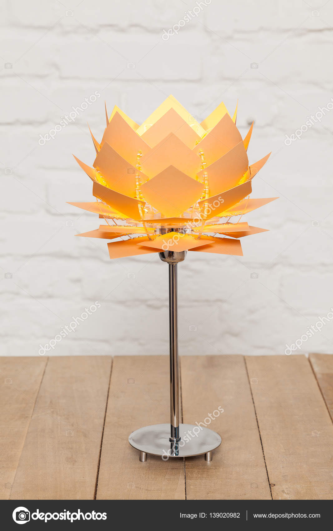 Front view of beige conceptual table lamp on wooden stand on white ...