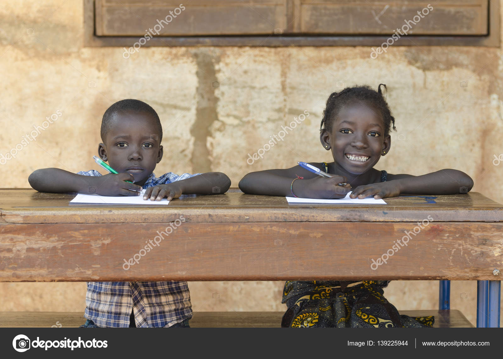 Two african children studying in school Stock Photo by ©borgogniels ...