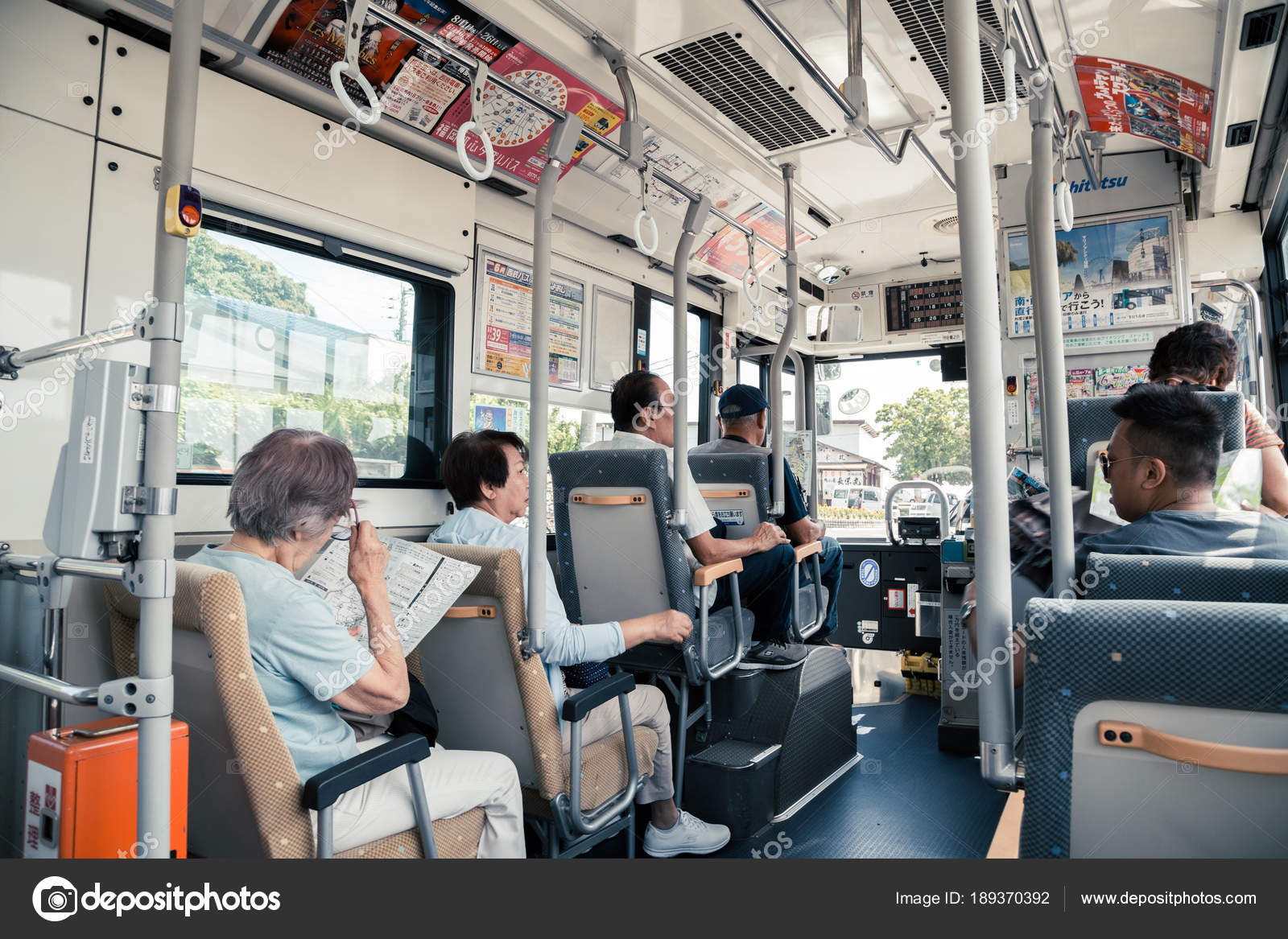 Inside bus with passengers in Japan — Stock Editorial Photo © SangaPark ...