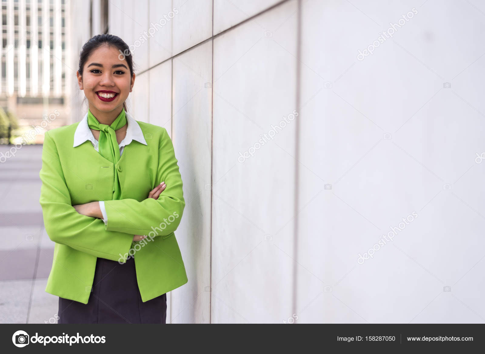 Young hostess woman or crew smiling with crossed arms Stock Photo by ...