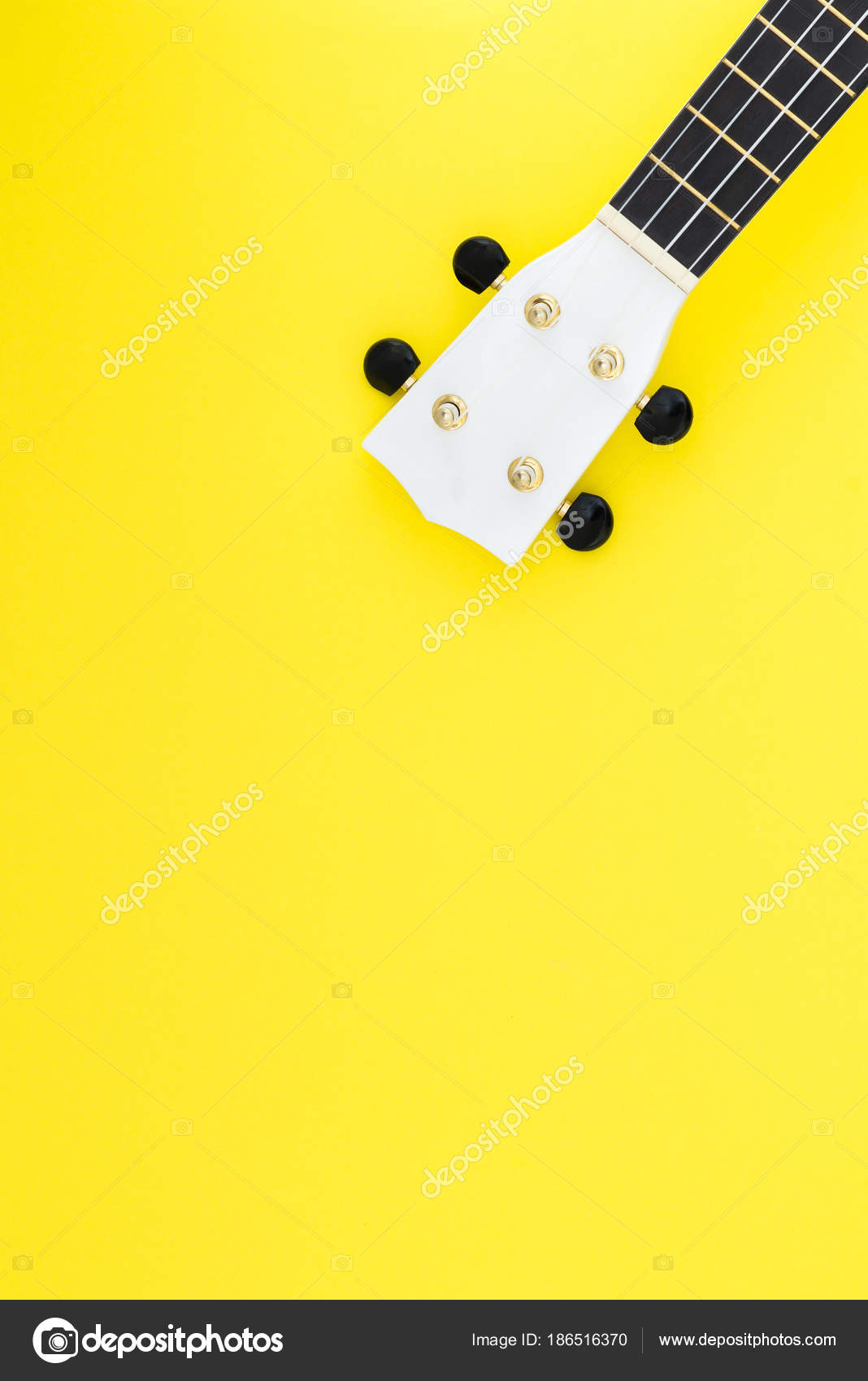 White ukulele on a yellow background and with a place for text. Musical ...