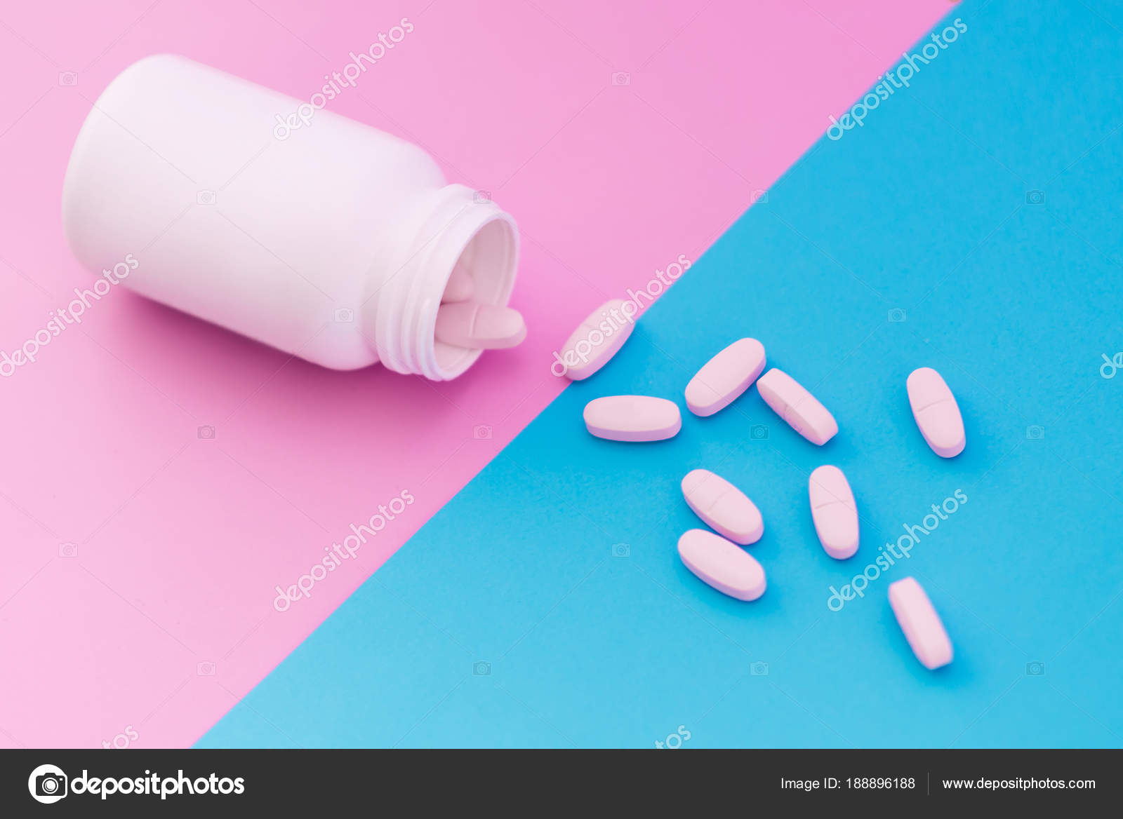 White pink and blue pill. Macro photo pills that pour out of a white ...