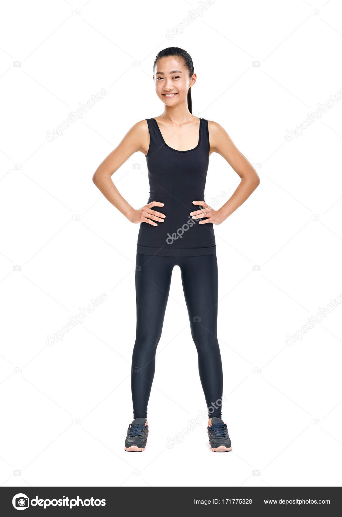 Woman standing with hands on hips Stock Photo by ©Gladkov 171775328