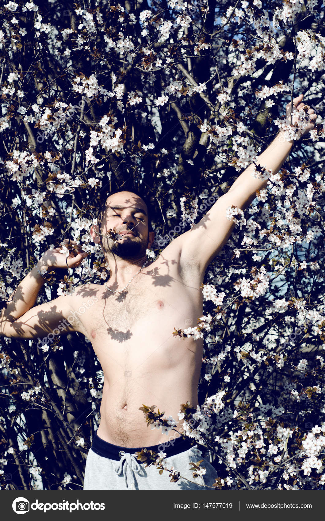 Man in spring flowers Stock Photo by ©focusandblur 147577019