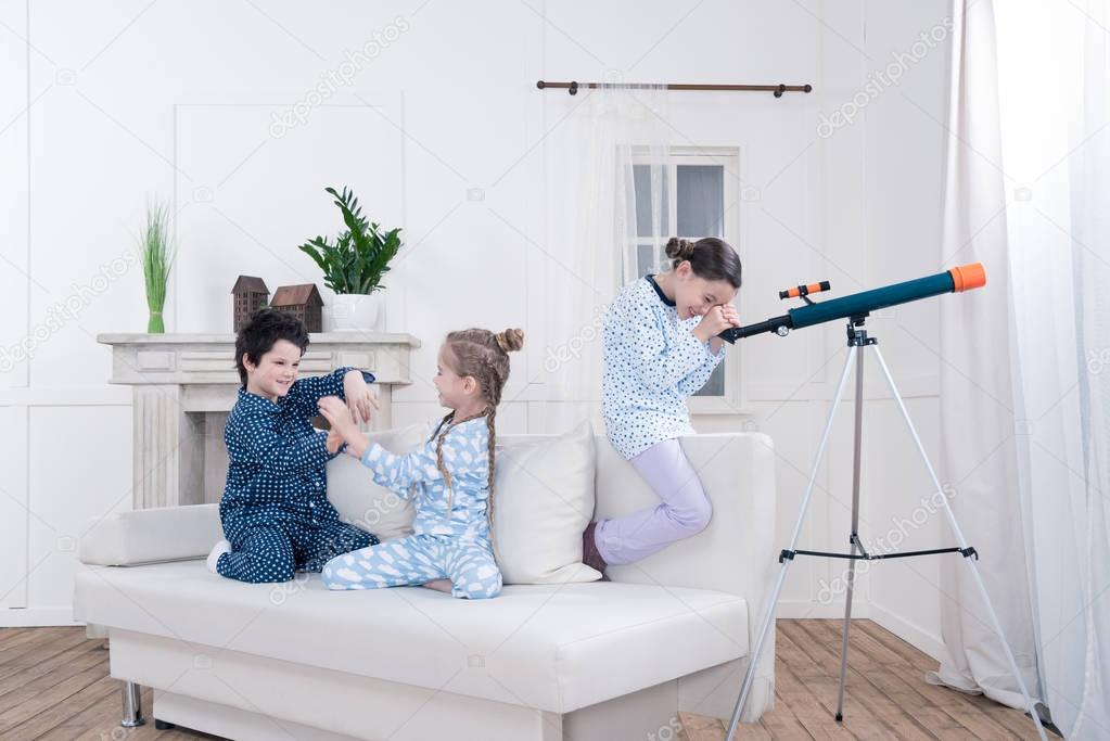 Kids playing with telescope — Stock Photo © ZaraMuzafarova #145065679