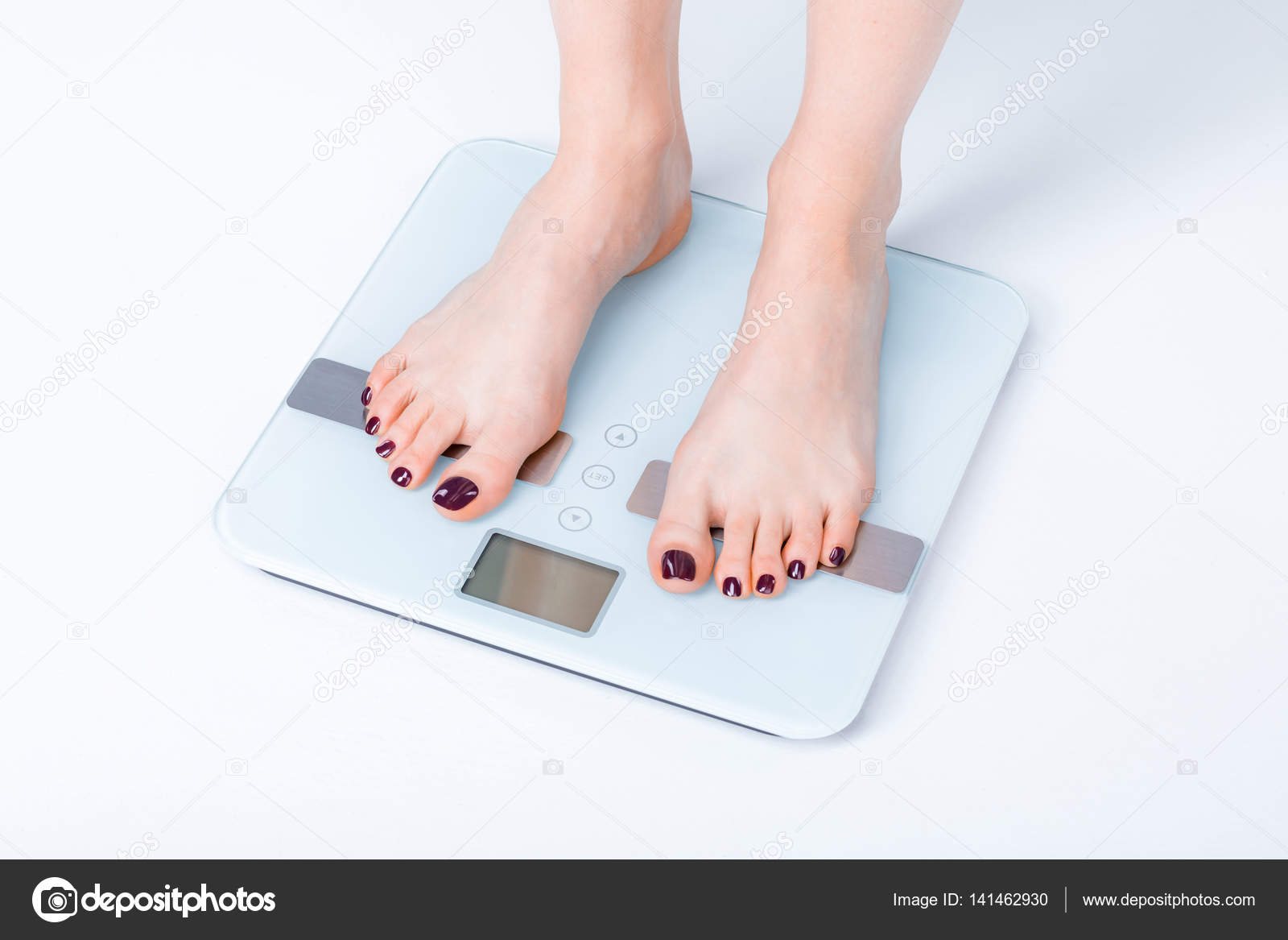 Woman on digital scales Stock Photo by ©VikaOvcharenko 141462930